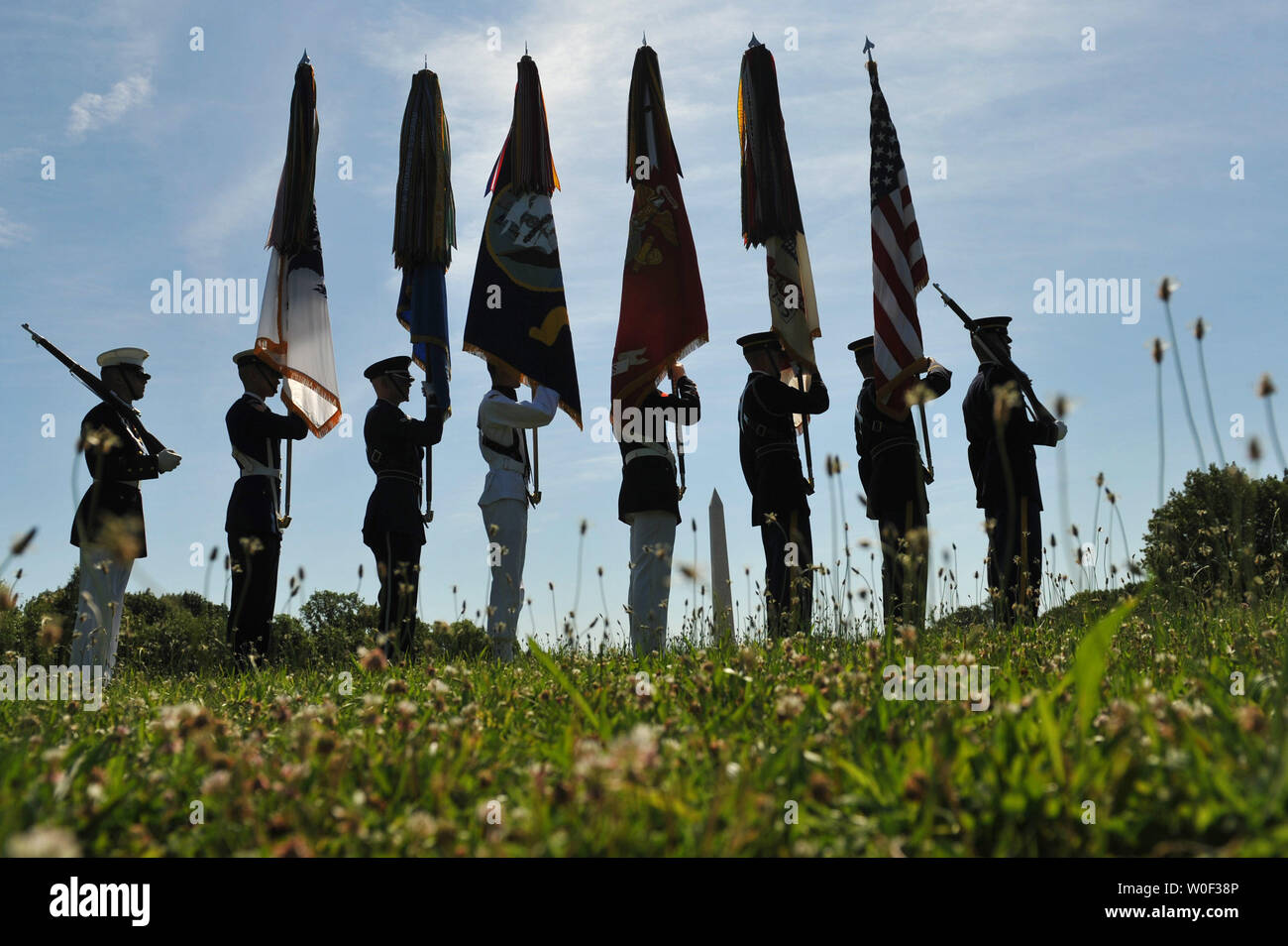 A military color guard participates in a ceremony to commemorate the ...