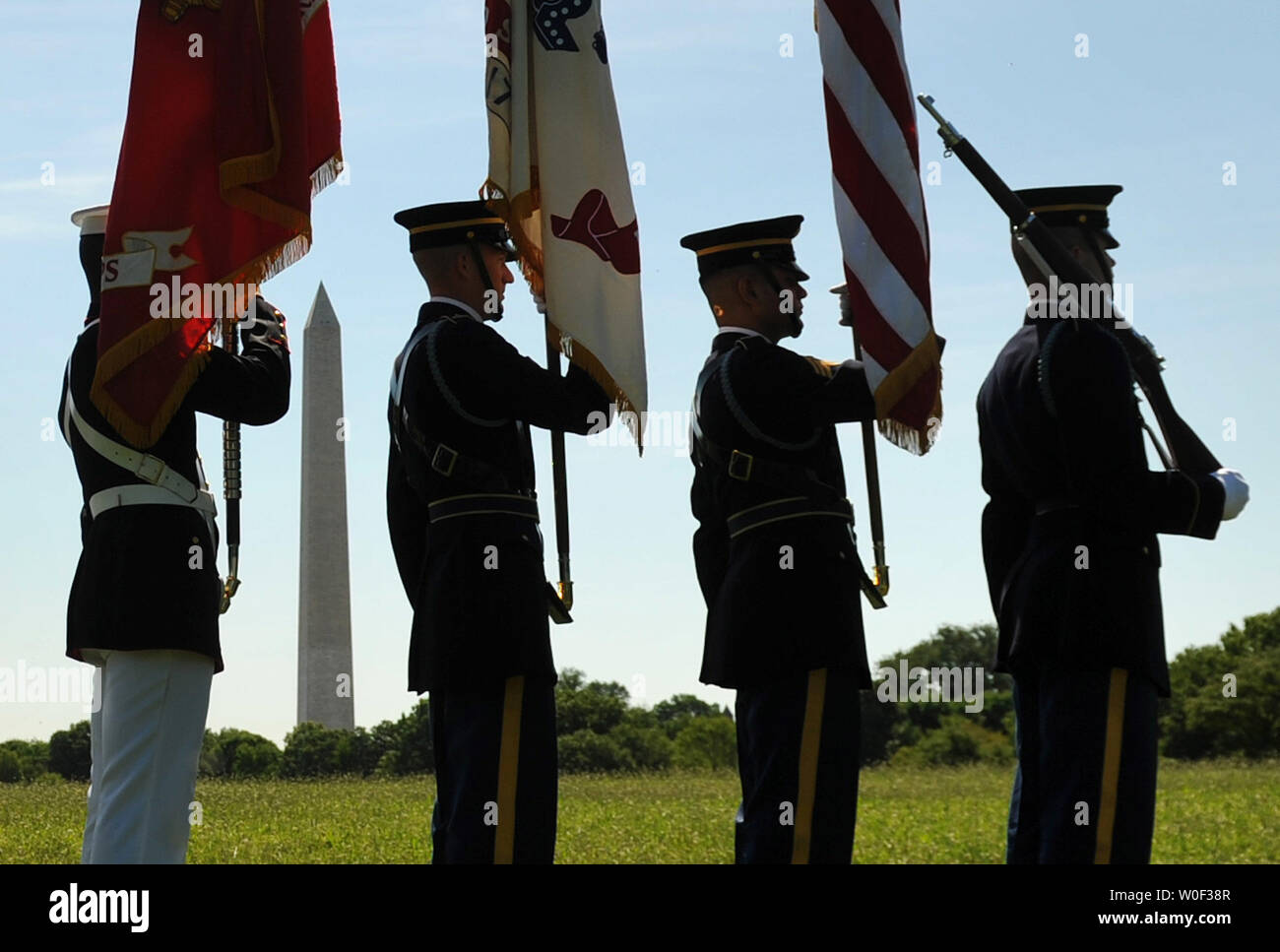 A military color guard participates in a ceremony to commemorate the ...