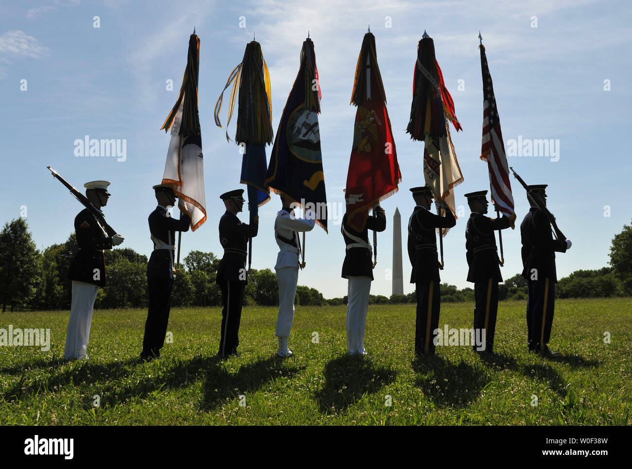 A military color guard participates in a ceremony to commemorate the ...