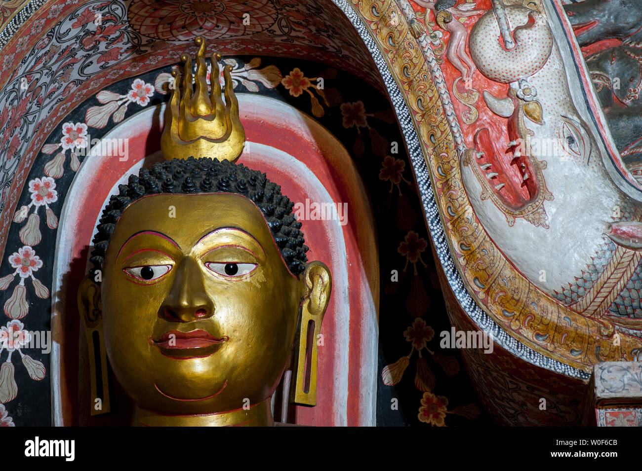 Head of golden Bouddha statue and weird painted creature, Lankathilake ...