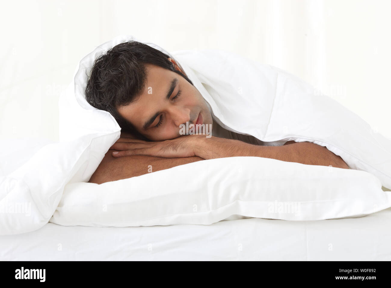 Indian man sleeping in bed hi-res stock photography and images - Alamy