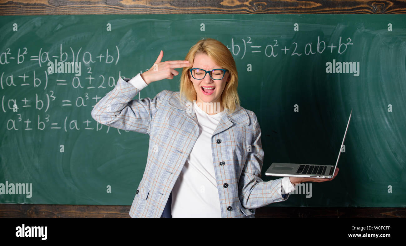 Educator smart clever lady with modern laptop hold gun gesture at her ...
