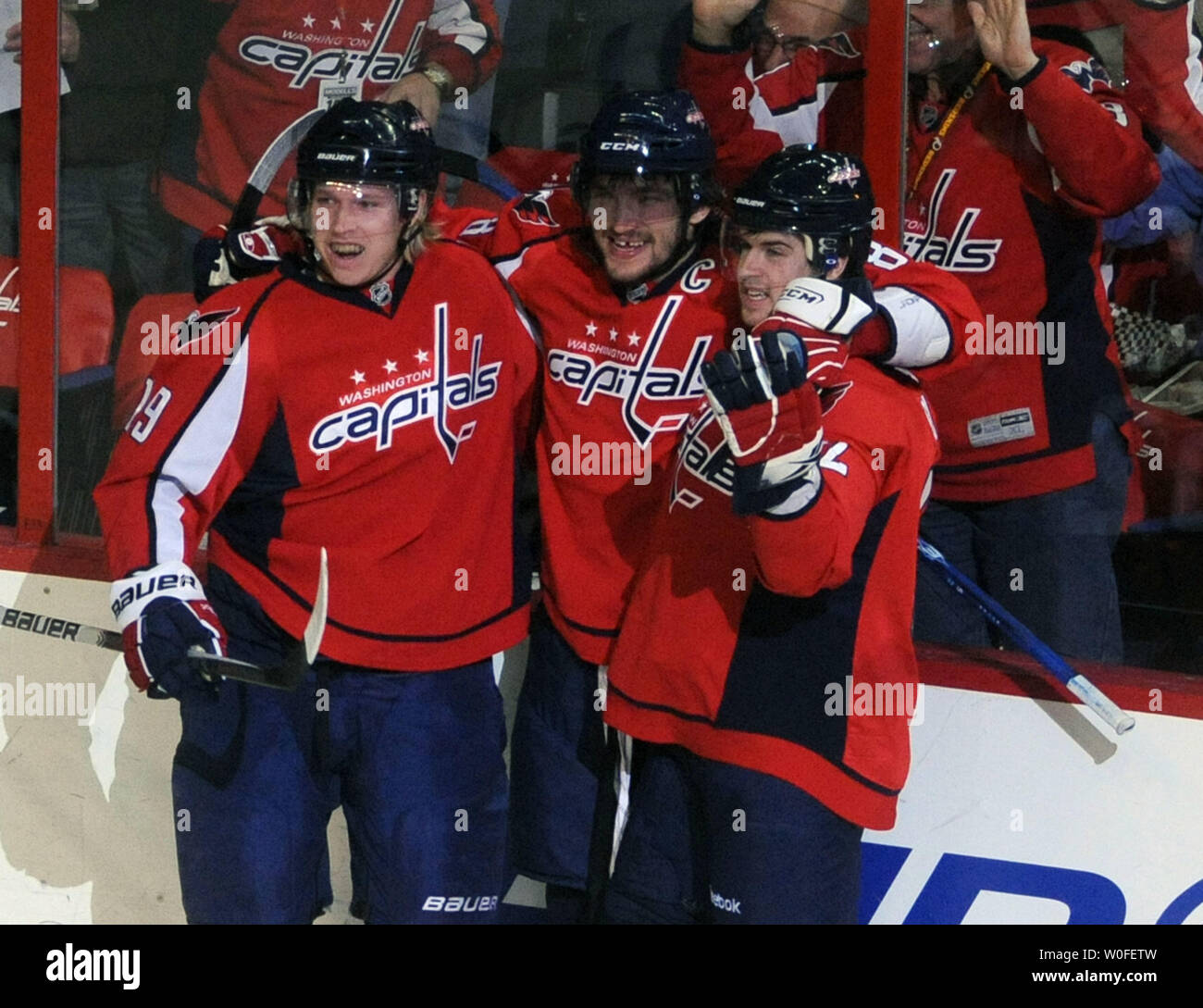 Washington Capitals team captain Alex Ovechkin (C) hugs teammates ...