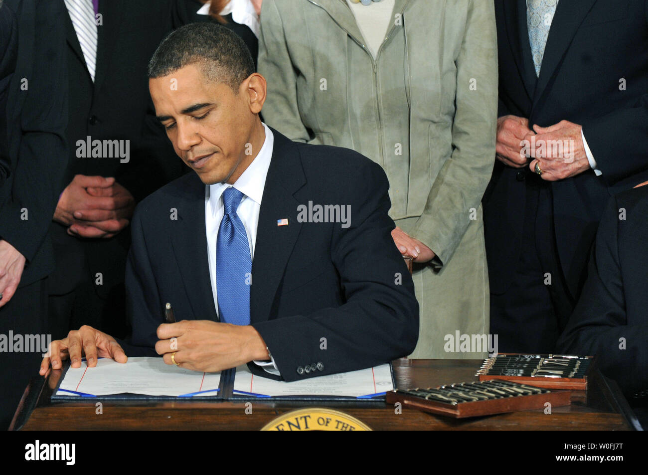 President Barack Obama signs the Health Insurance Reform Bill in the ...