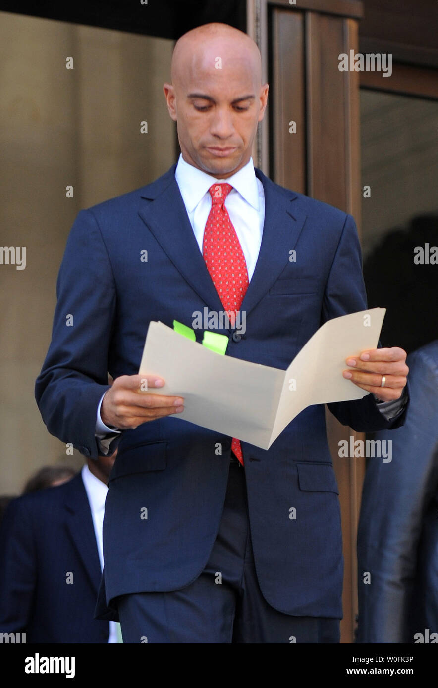Washington, D.C. Mayor Adrian Fenty walks to the podium holding a copy ...