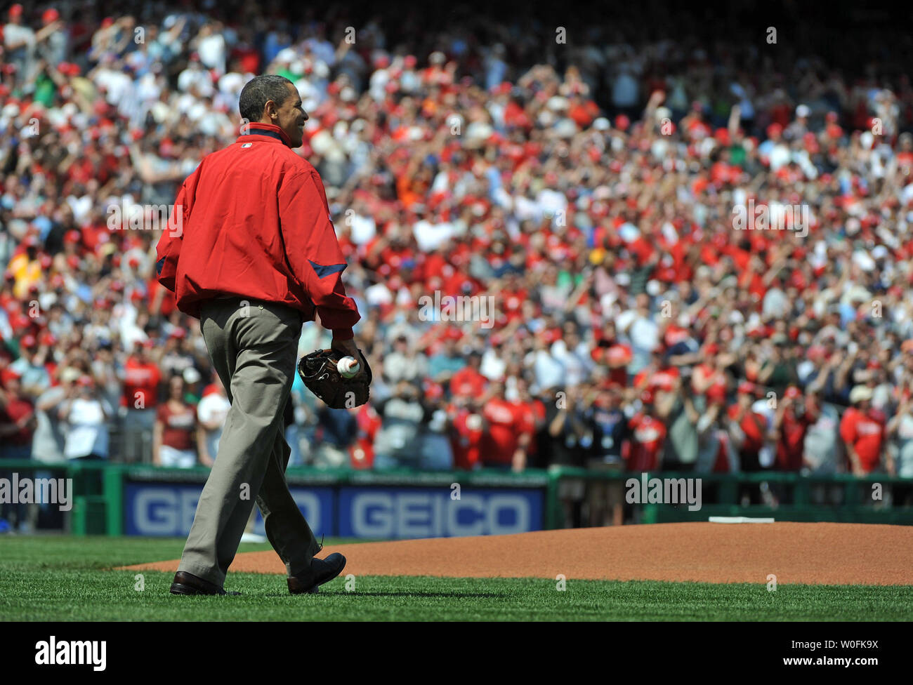 U.S. President Barack Obama walks to the mound prior to throwing out ...