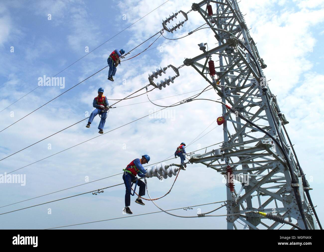 June 27, 2019, Chuzhou, Anhui, China: Electrical workers balance ...