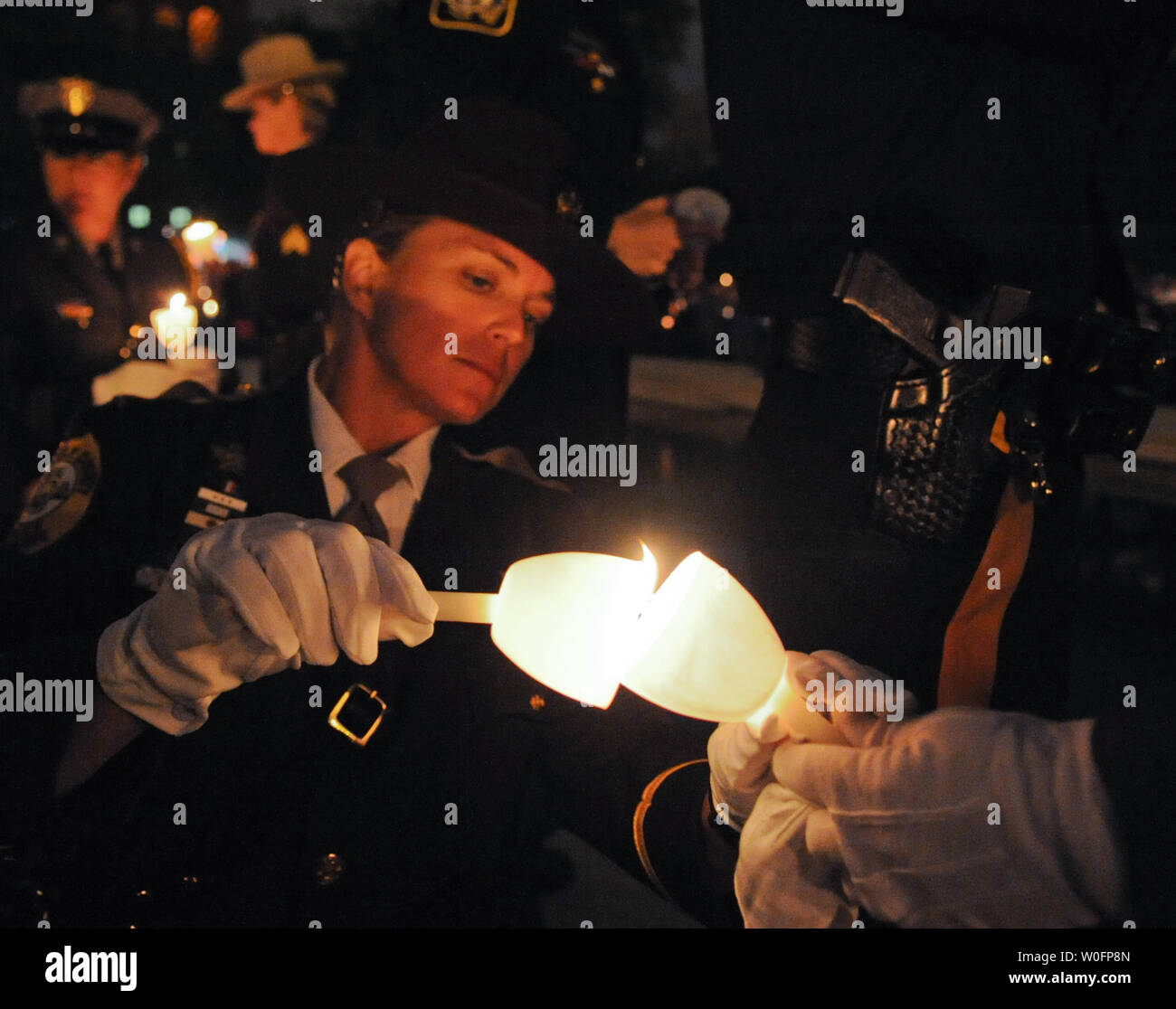 Surviving family members and friends light candles at the 22nd Annual ...