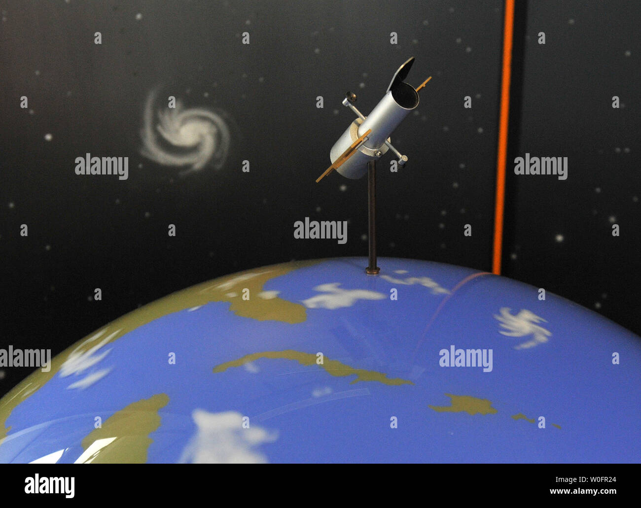 A model of the Hubble Space Telescope orbiting the Earth is seen in the ...