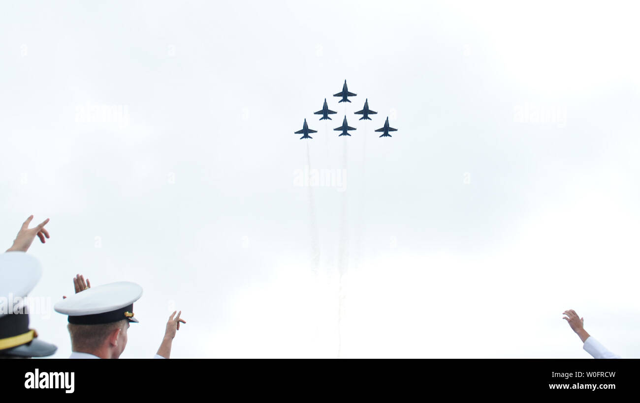Navy midshipmen cheer as the Navy Blue Angels fly over at the U.S ...