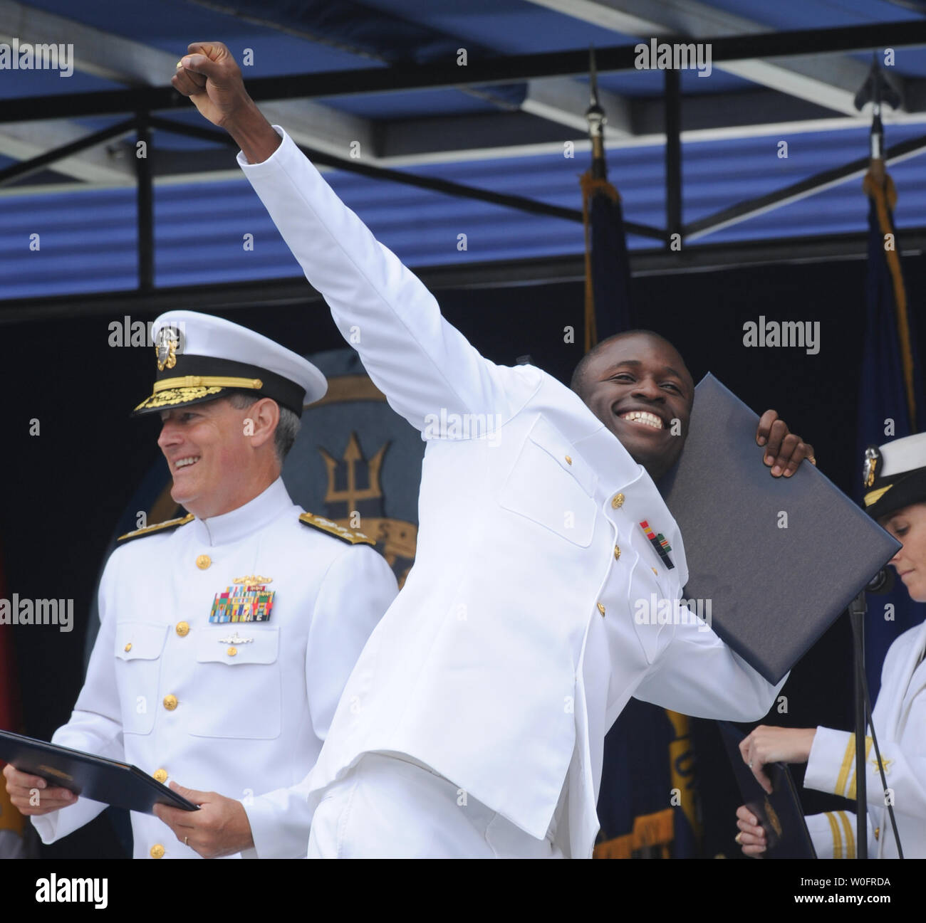 A Navy midshipmen celebrates after receiving his diploma at the U.S ...