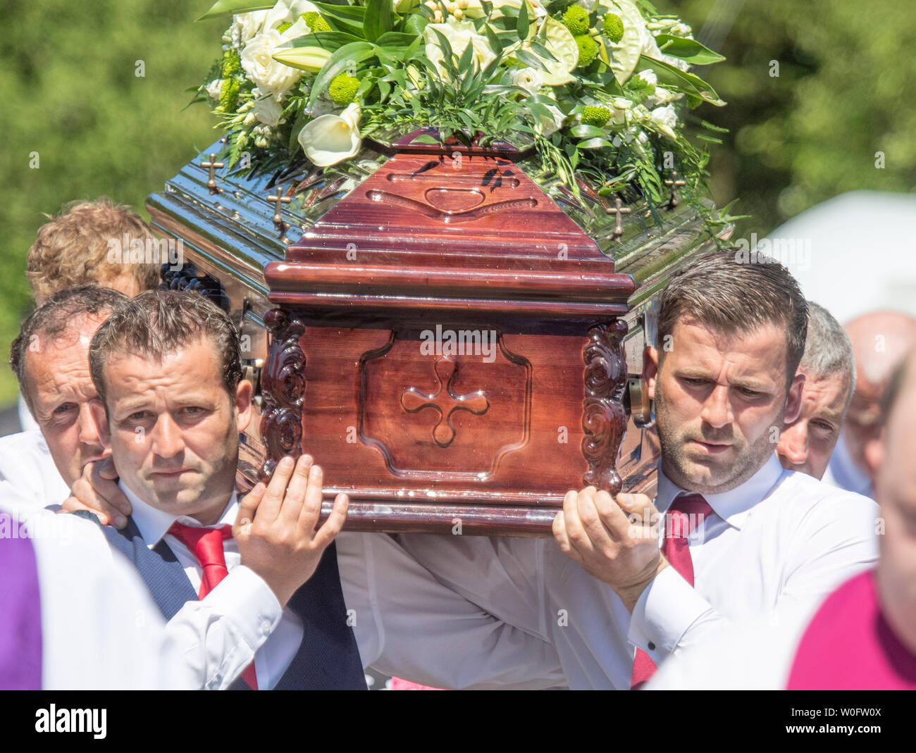 The coffin of rally driver Manus Kelly is taken from St Columba's ...
