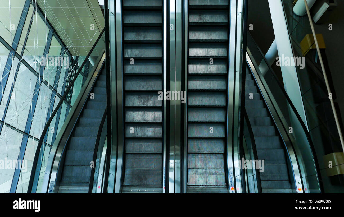 Escalators going up and down abstract. Four escalators two ascending ...