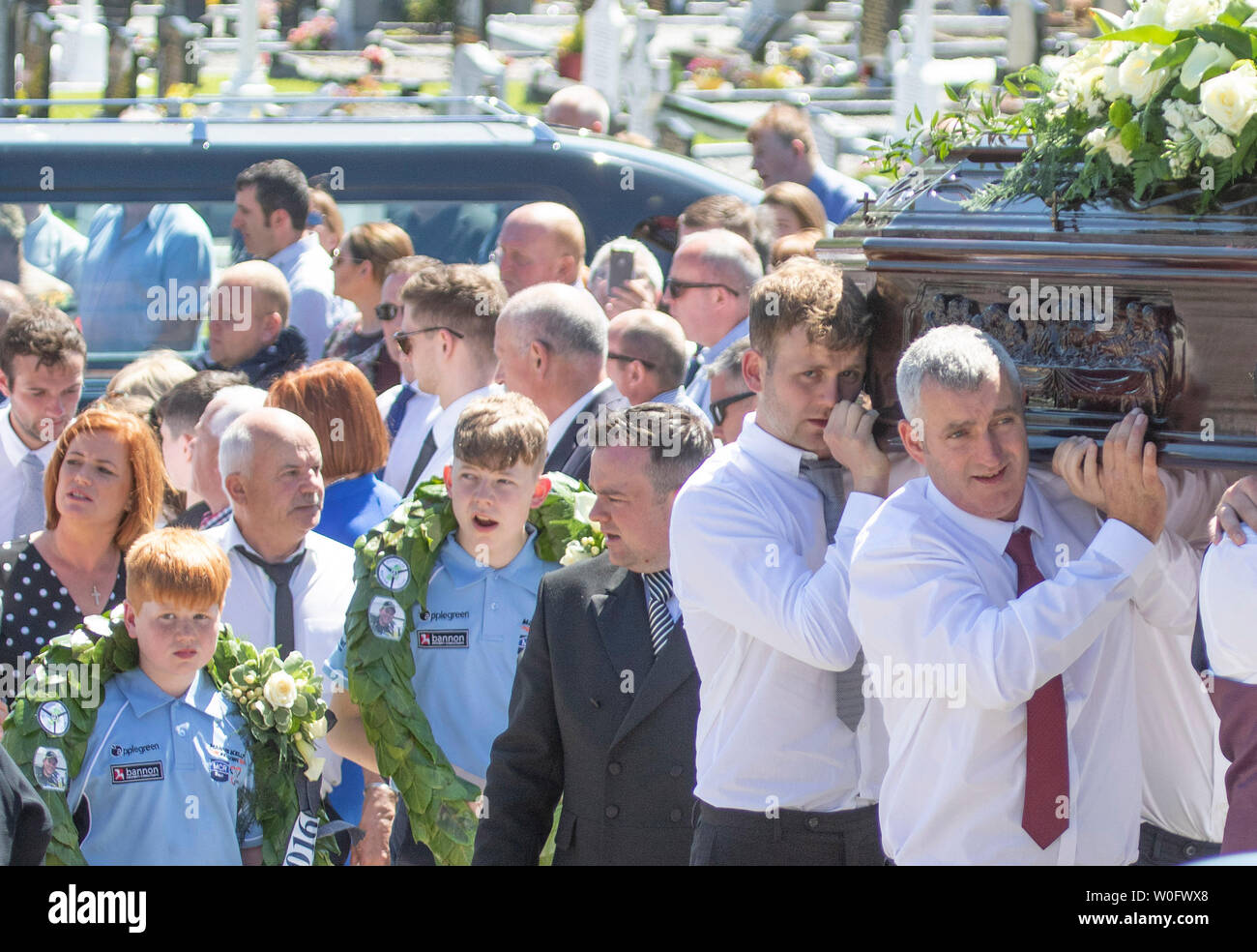 The remains of the late rally driver Manus "Mandy" Kelly are carried ...