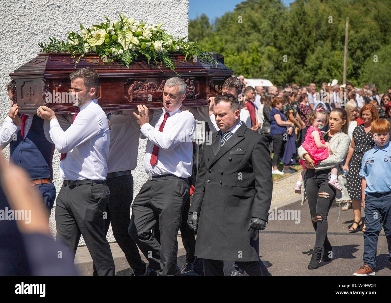 The coffin of rally driver Manus Kelly is taken from St Columba's ...