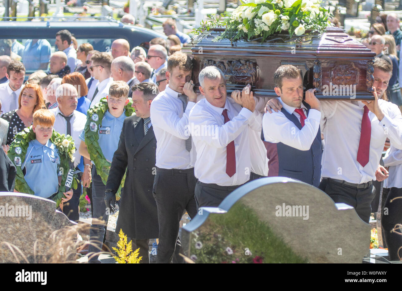 The remains of the late rally driver Manus "Mandy" Kelly are carried ...