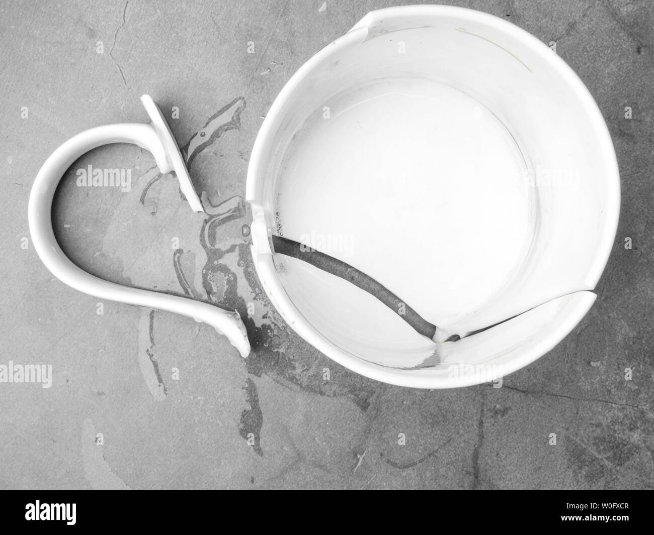 Broken white cup pieces on c0ncrete background Stock Photo - Alamy
