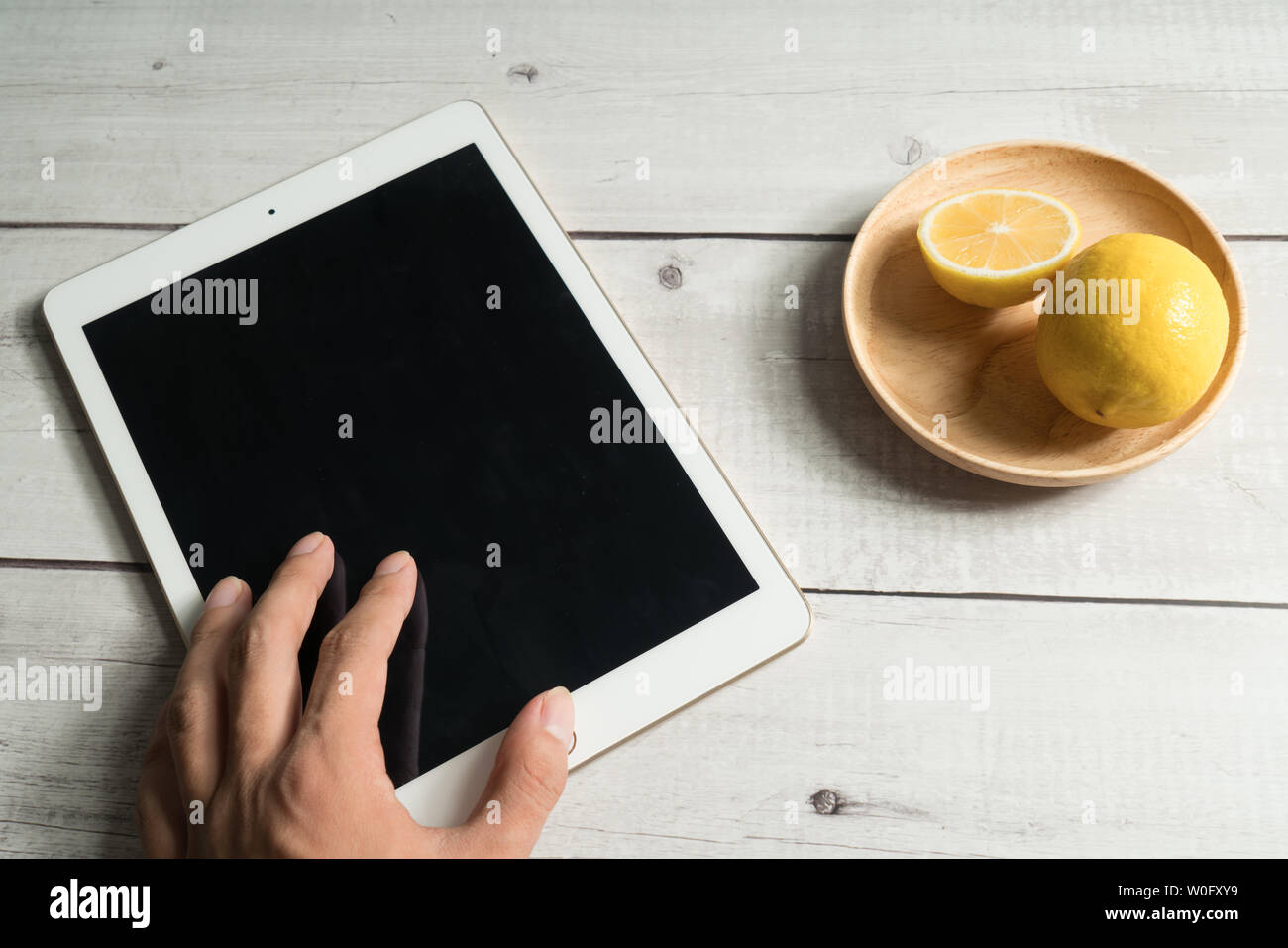 Lemon with tablet Stock Photo - Alamy