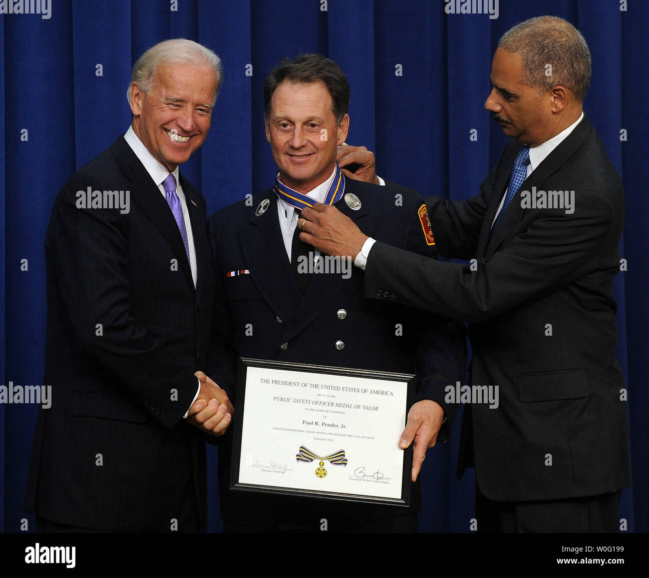 Attorney General Eric Holder adjusts Lt. Paul Pender, Jr.'s medal as ...