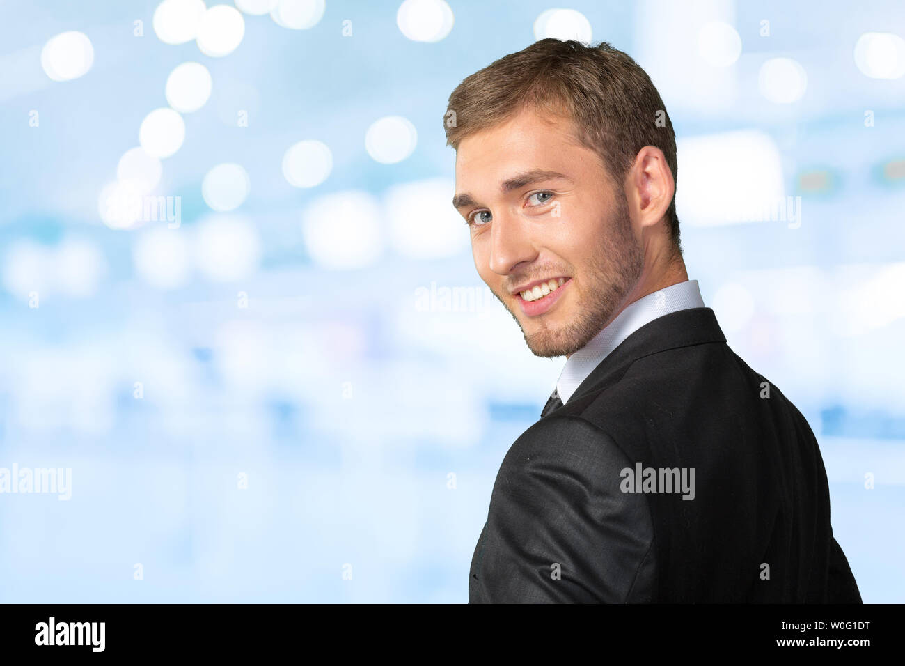 Young Businessman looking over his shoulder Stock Photo - Alamy