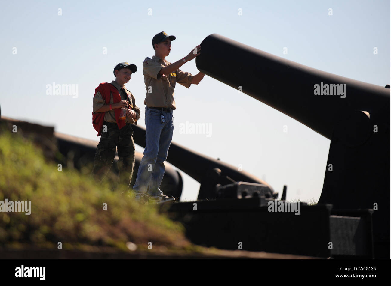 A Boy Scout looks at a cannon during the Star-Spangled Camporee and ...