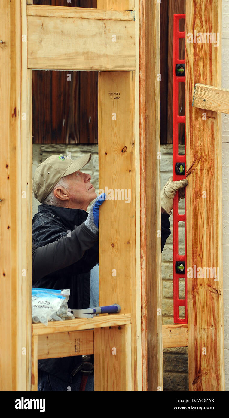 Former President Jimmy Carter works on a house as part of the Habitat ...