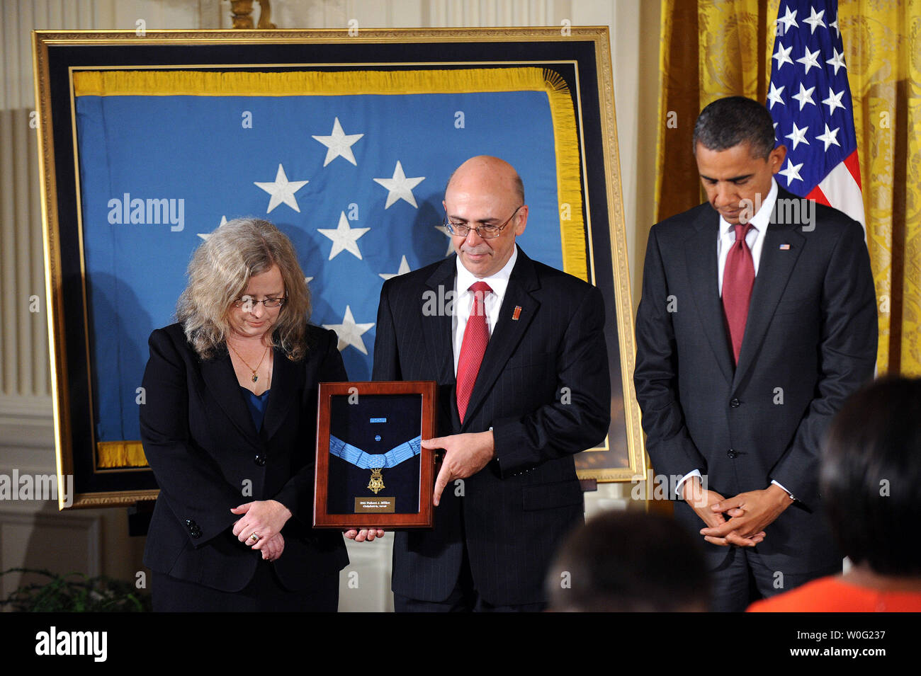 President Barack Obama, joined by Paul and Maureen Miller, the parents ...