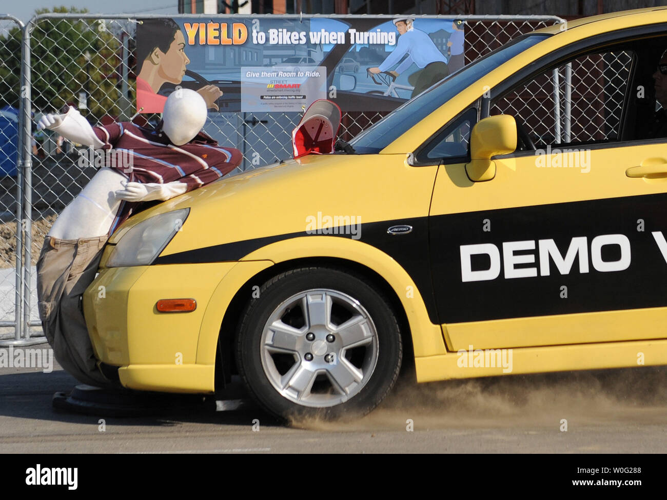 A dummy is hit by a car during a pedestrian safety demonstration ...
