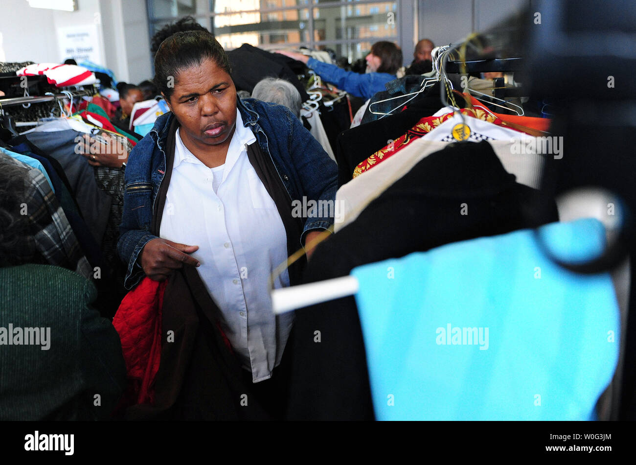 A woman looks through a rack of donated clothing at the 11th Annual ...