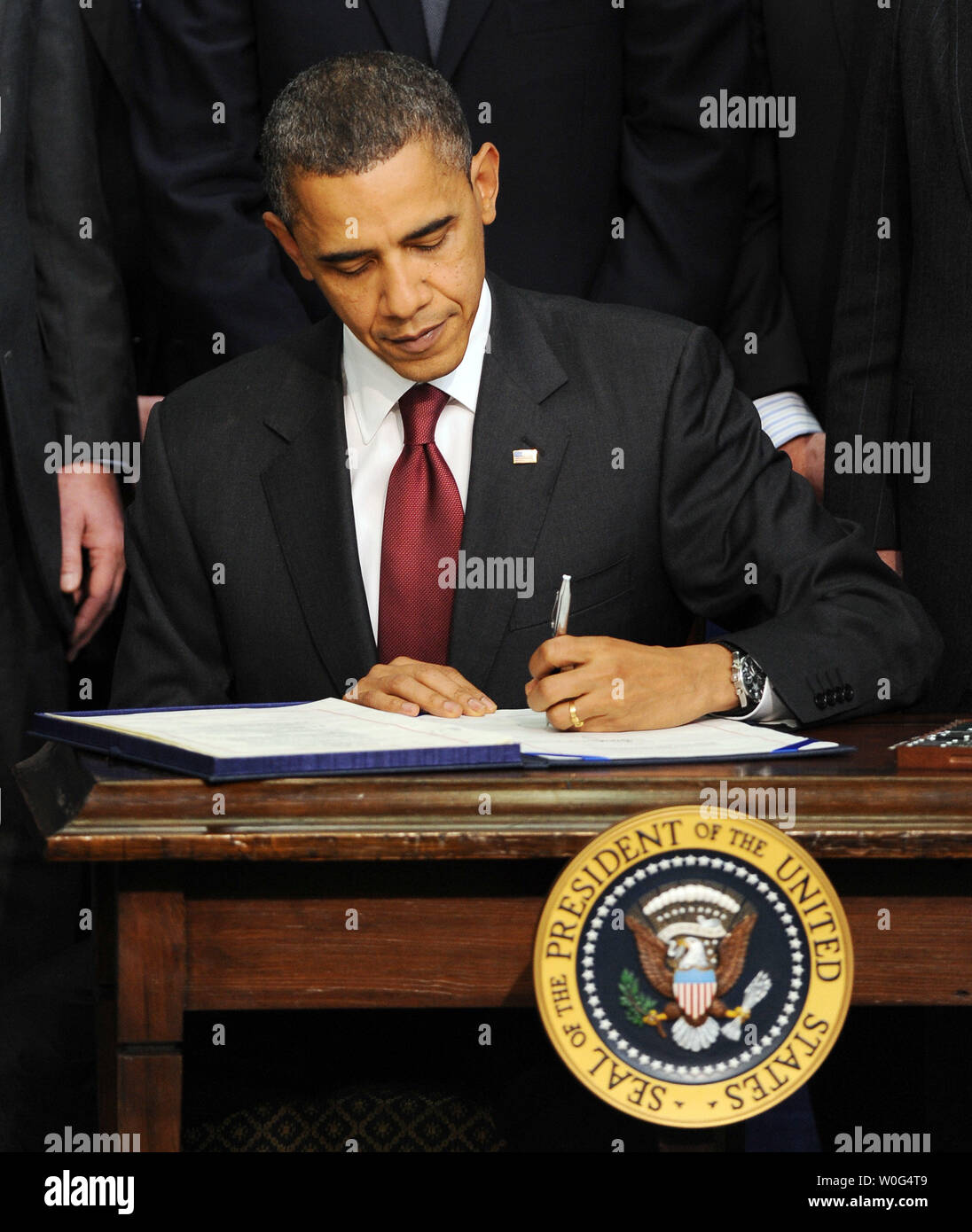 U.S. President Barack Obama signs the middle-class tax cut bill in the ...