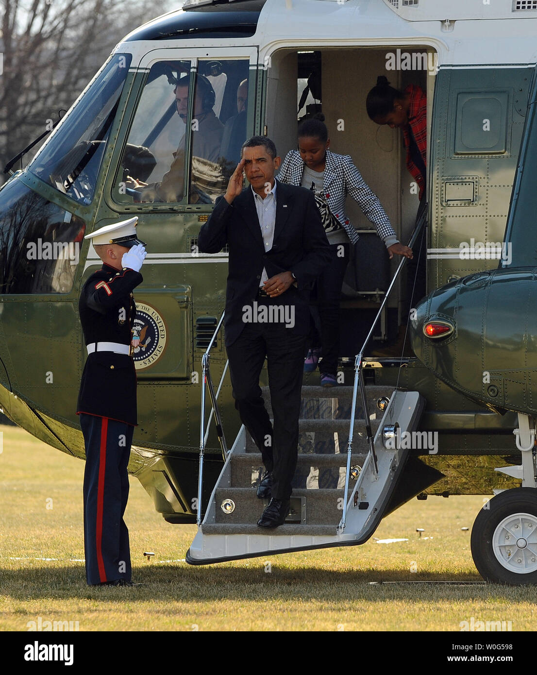 U.S. President Barack Obama salutes as the First Family walks from ...
