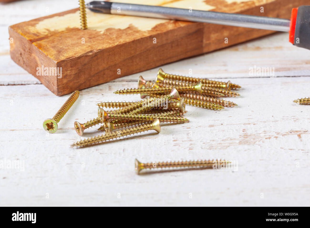 screws on a wooden table Stock Photo - Alamy