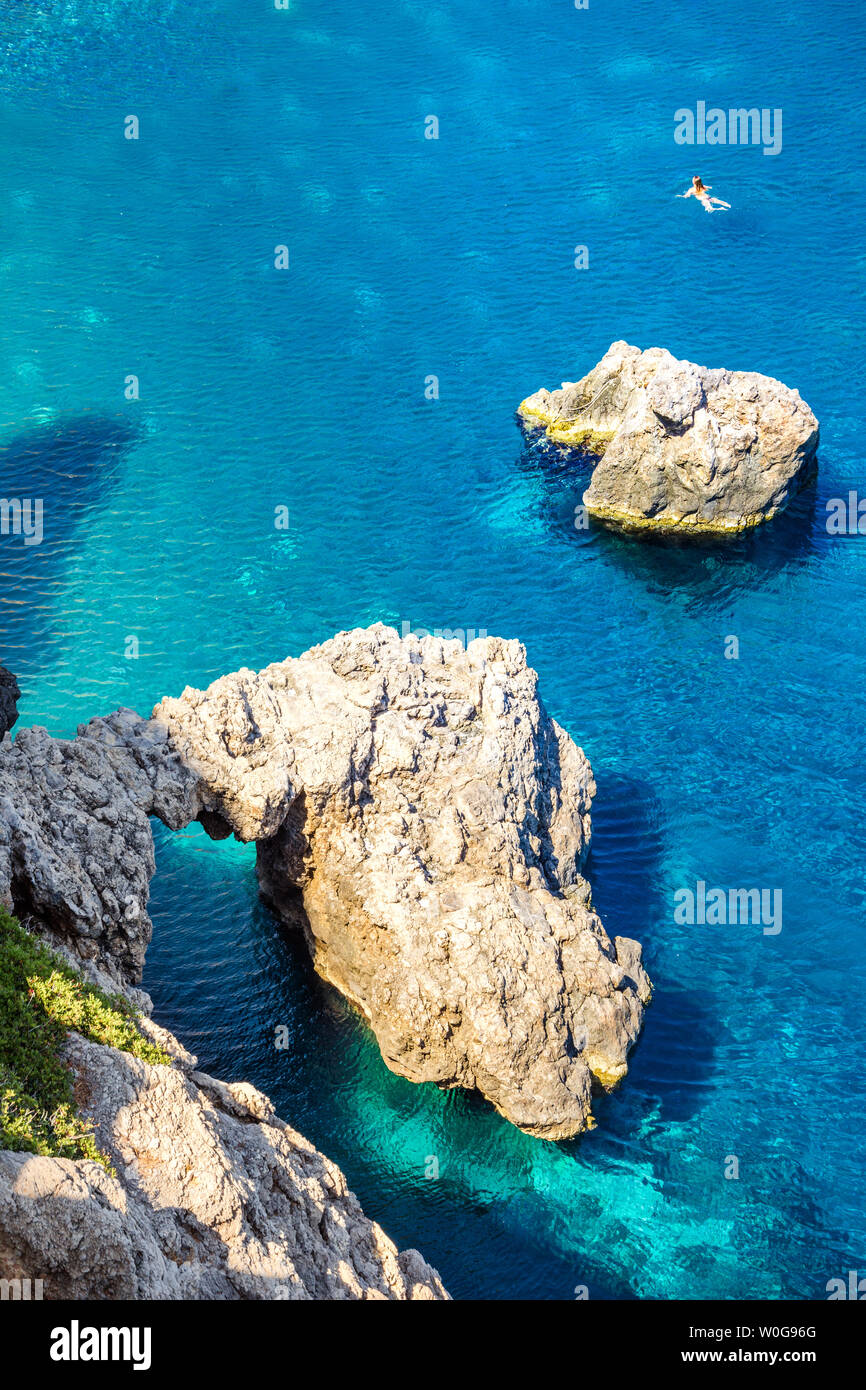 Agiofarago beach with natural caves and stone arches at the end of the ...