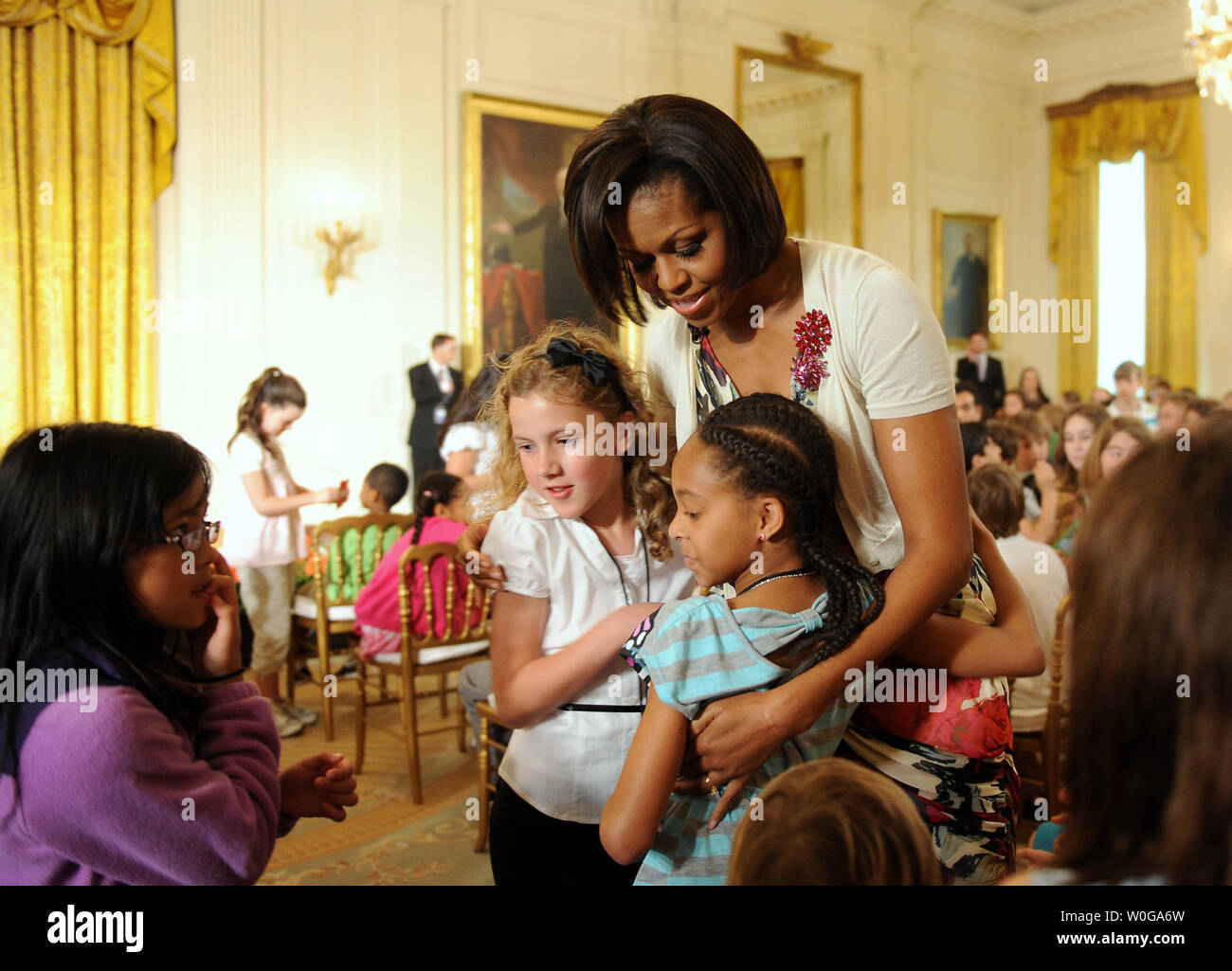 First Lady Michelle Obama hugs children of Executive Office employees ...