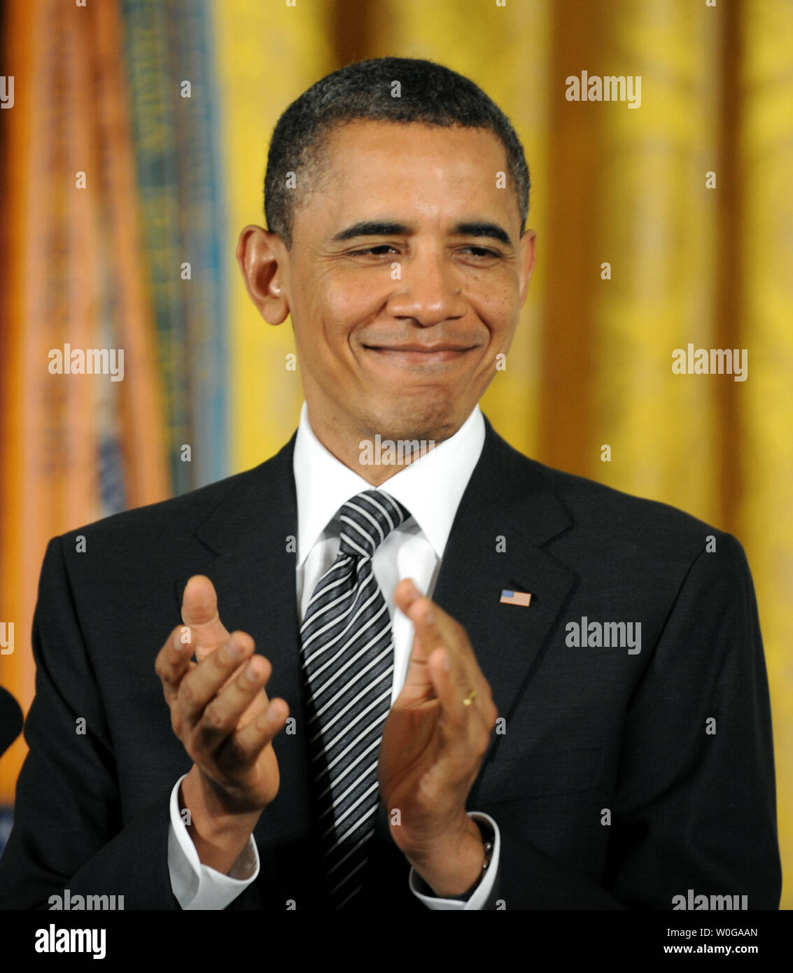 U. S. President Barack Obama applauds during ceremony to award ...