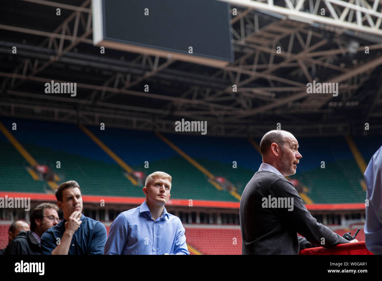 A Principality Stadium tour guide speaks at pitch-side Stock Photo - Alamy