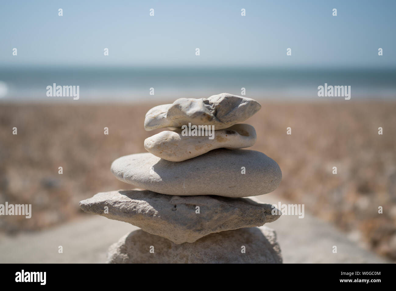 Stone cairn rock pile on the beach by the sea Stock Photo - Alamy