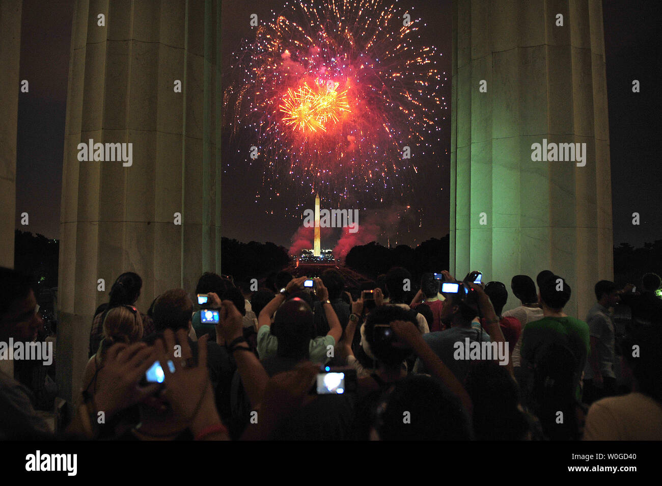 People watch from the Lincoln Memorial as fireworks explode over the ...