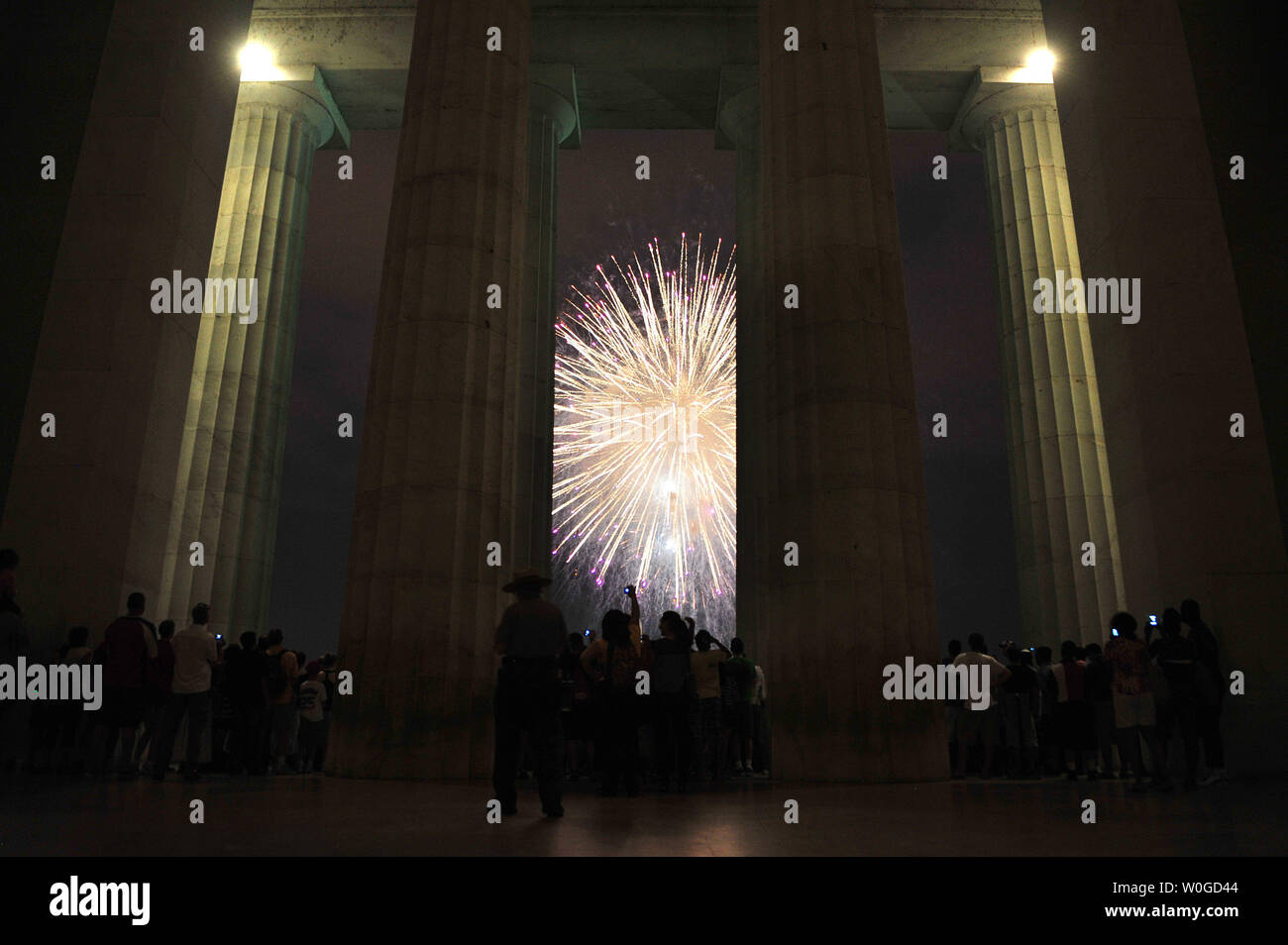 People watch from the Lincoln Memorial as fireworks explode over the ...
