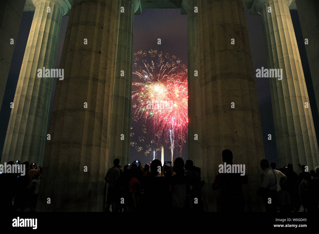People watch from the Lincoln Memorial as fireworks explode over the ...
