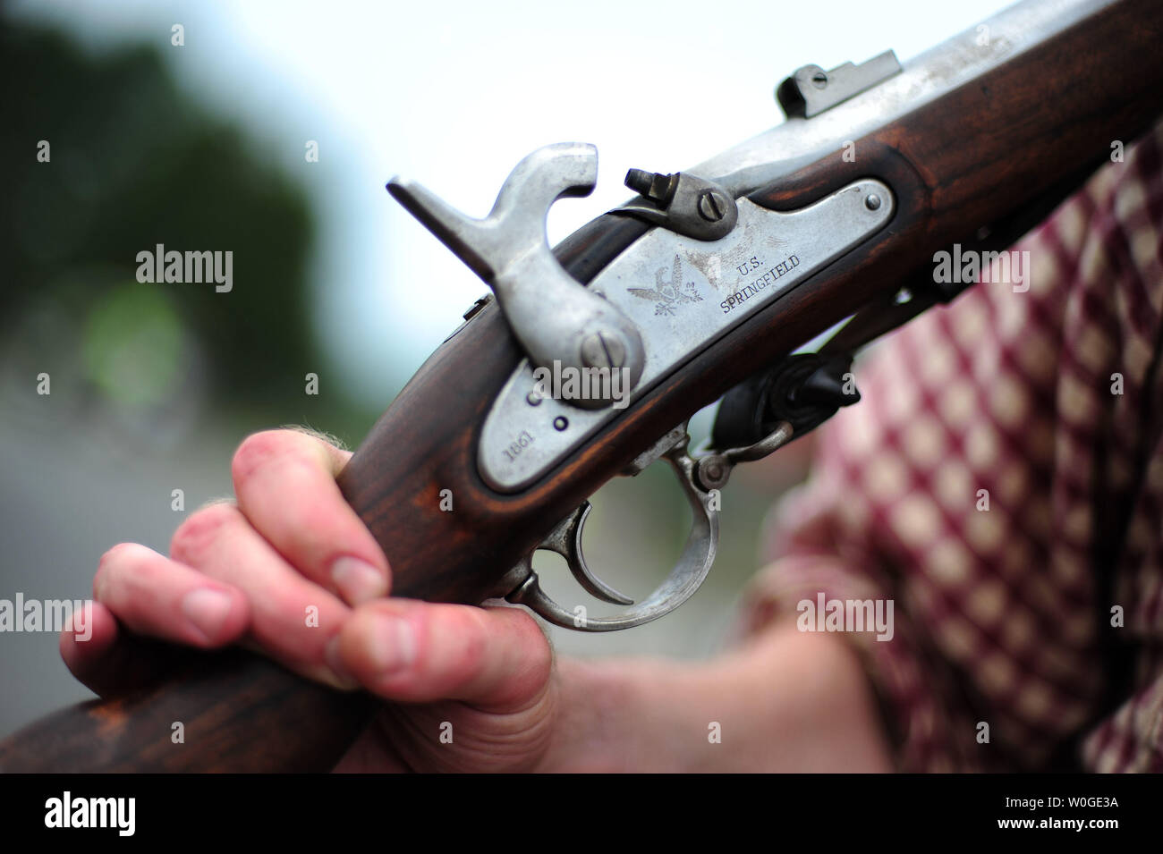 A Civil War reenactor holds a Springfield rifle during the reenactment ...