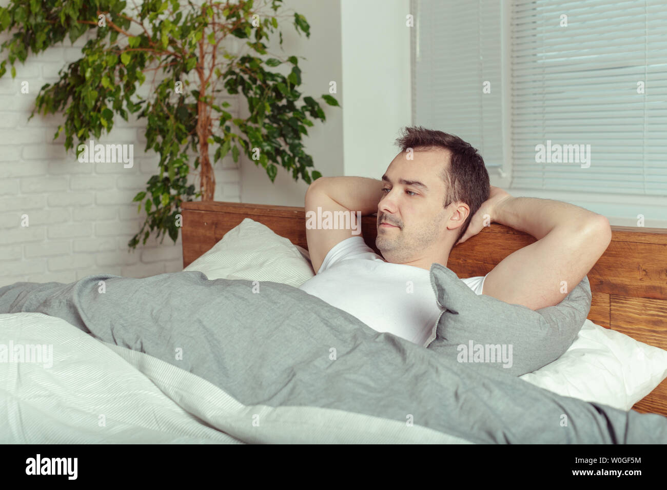 Young Man Sleeping On Bed In Bedroom Stock Photo - Alamy