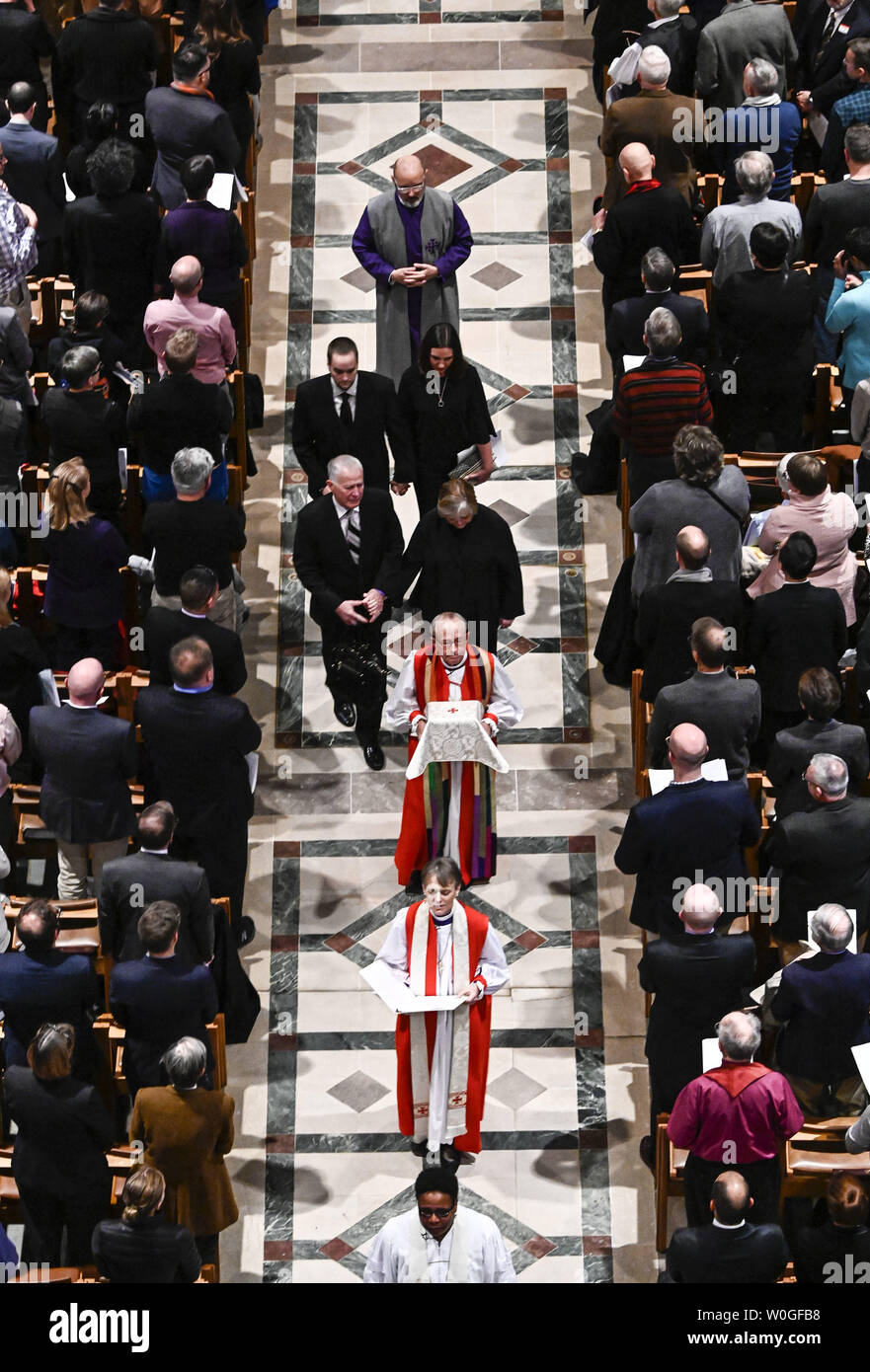 Bishop Gene Robinson carries the remains of Matthew Shepard, followed ...