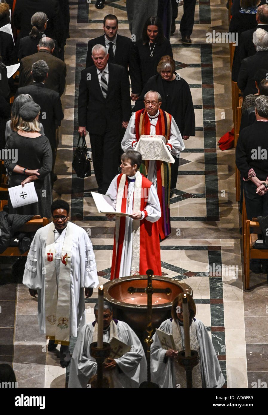 Bishop Gene Robinson carries the remains of Matthew Shepard, followed ...