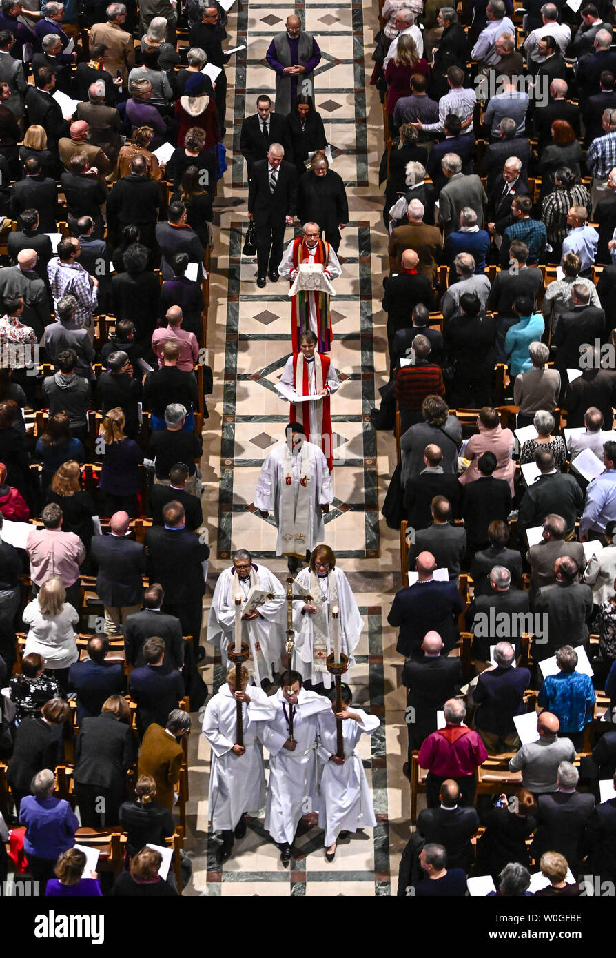 Bishop Gene Robinson carries the remains of Matthew Shepard, followed ...