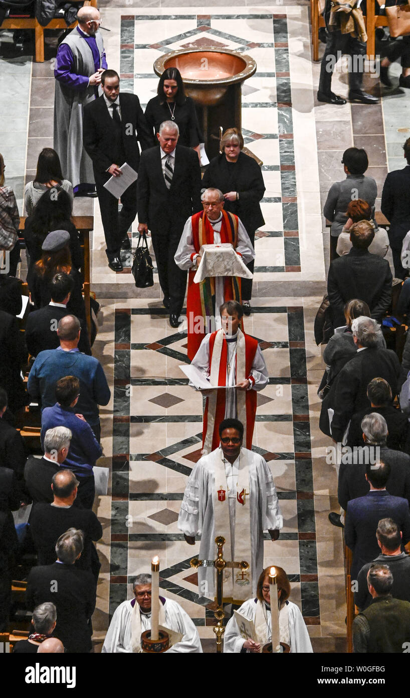 Bishop Gene Robinson carries the remains of Matthew Shepard, followed ...