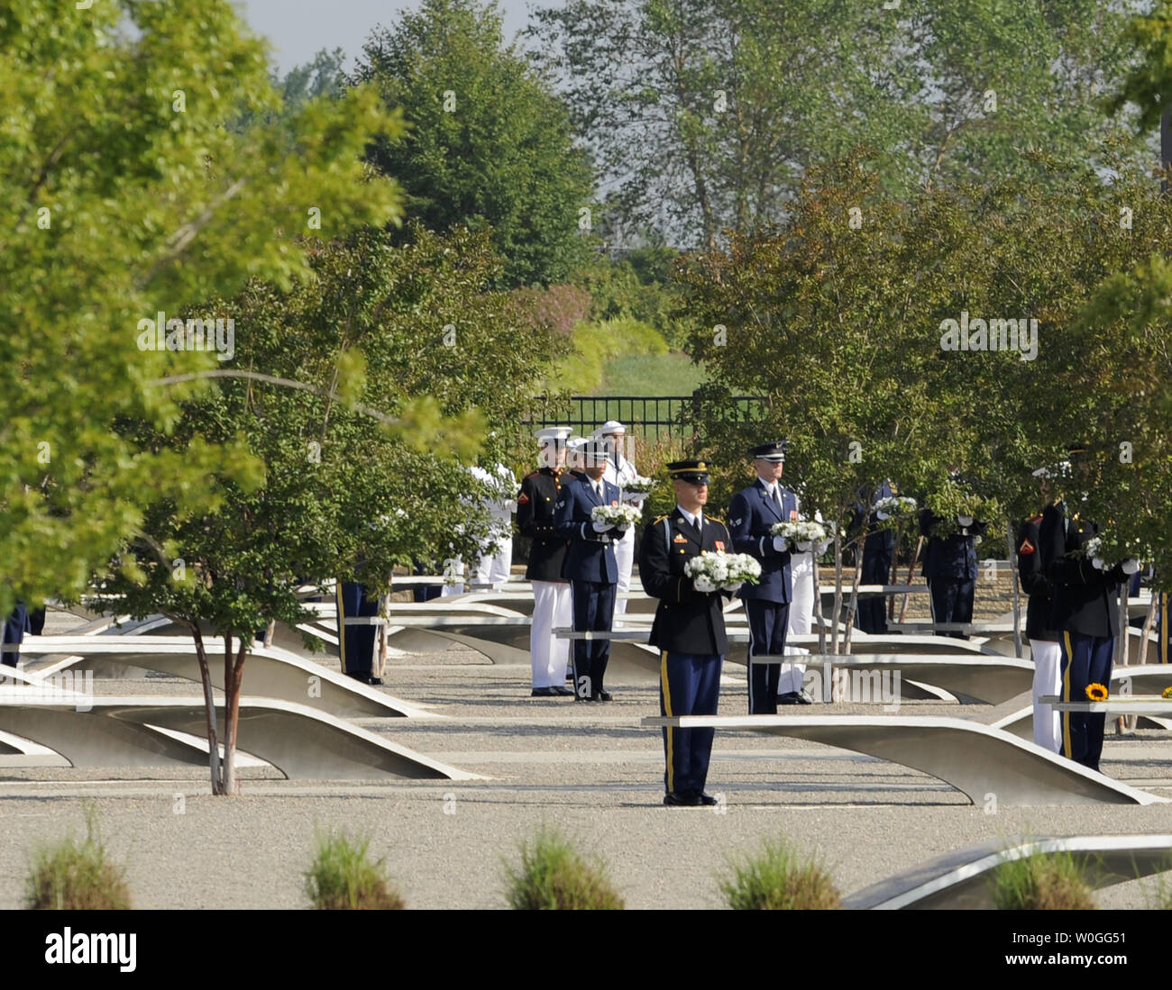 Honor Guard prepares to lay wreaths on each of the 184 benches of the ...