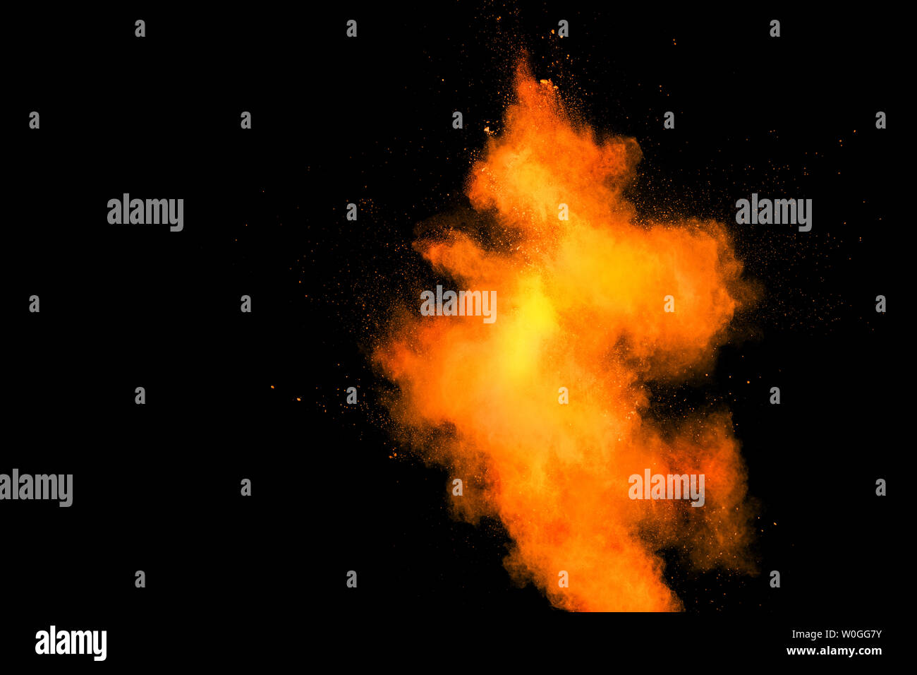 Orange color powder splatter on black background. Color particles ...