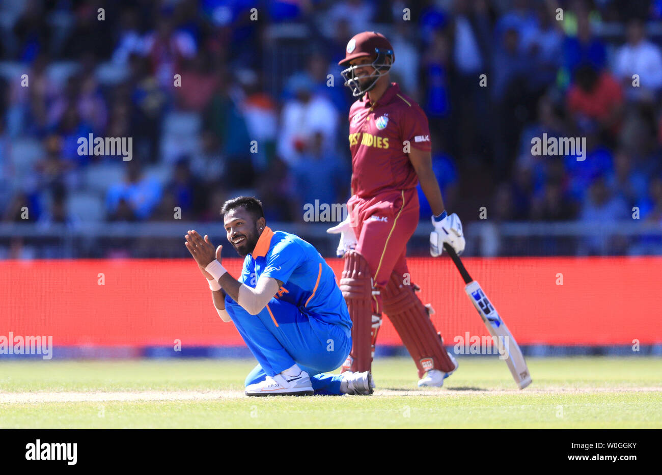 India's Hardik Pandya (left) celebrates taking the wicket of West ...