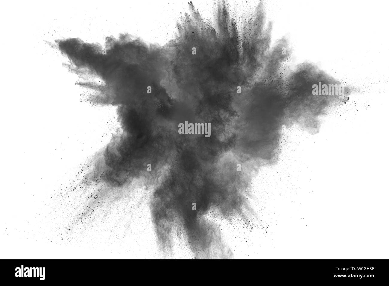 Black powder explosion against white background.Black dust particles ...